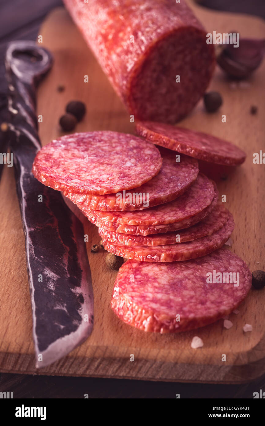 Sliced salami on cutting board closeup Stock Photo - Alamy