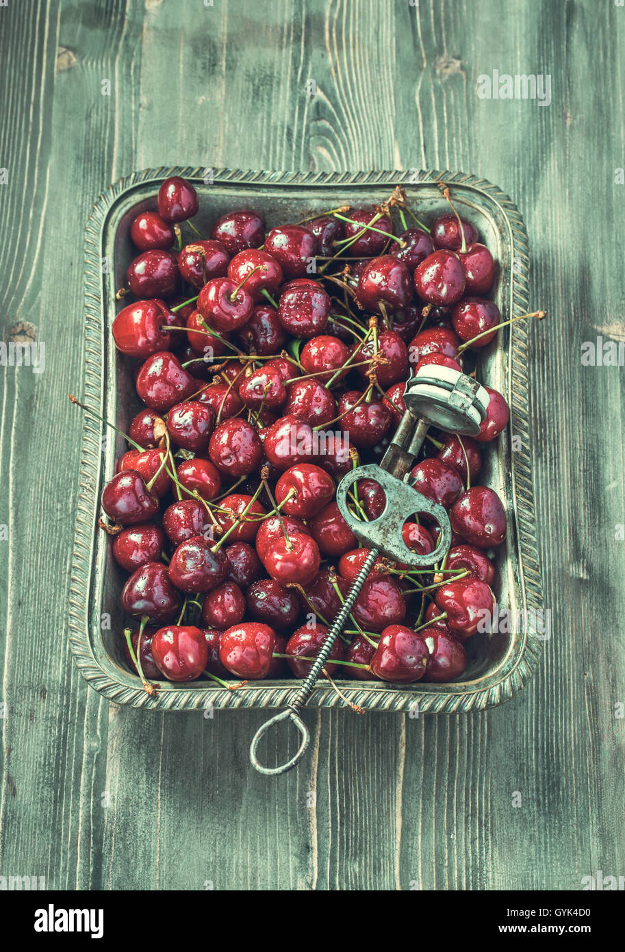 Tray of cherries with stone remover Stock Photo - Alamy