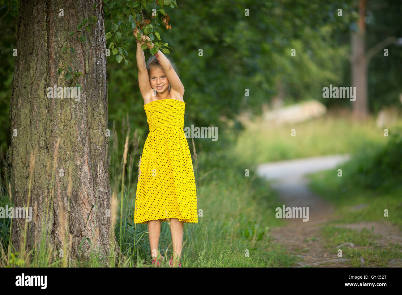 Little girl in a Park near a tree Stock Photo - Alamy
