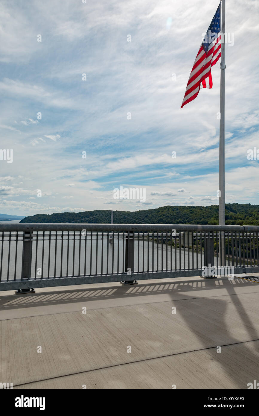 Vertical view on the Walkway Over the Hudson with a flag near the ...