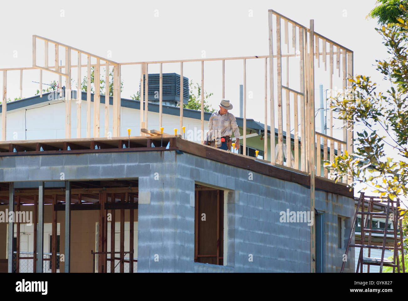 Builder constructing timber frame for new two storey house Stock Photo ...