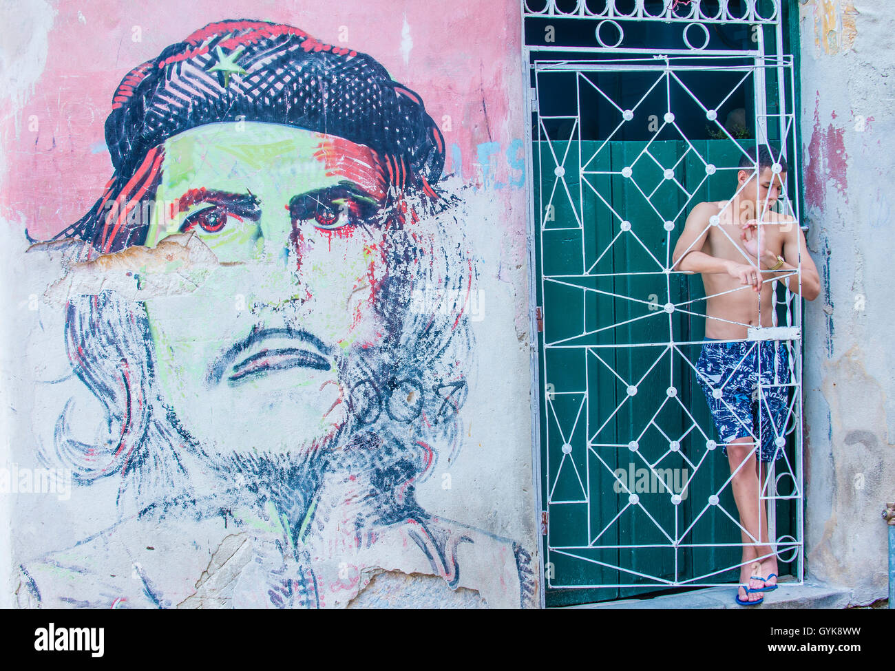 HAVANA, CUBA - JULY 18 : Cuban man stand near mural of Che Guevara in ...