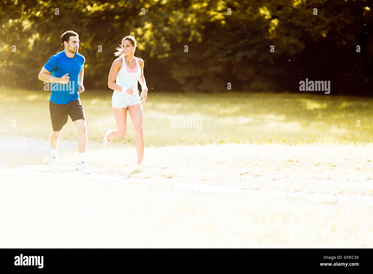 Young people jogging and exercising in nature Stock Photo - Alamy