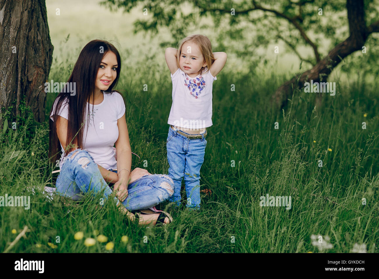 child near tree with mom Stock Photo - Alamy