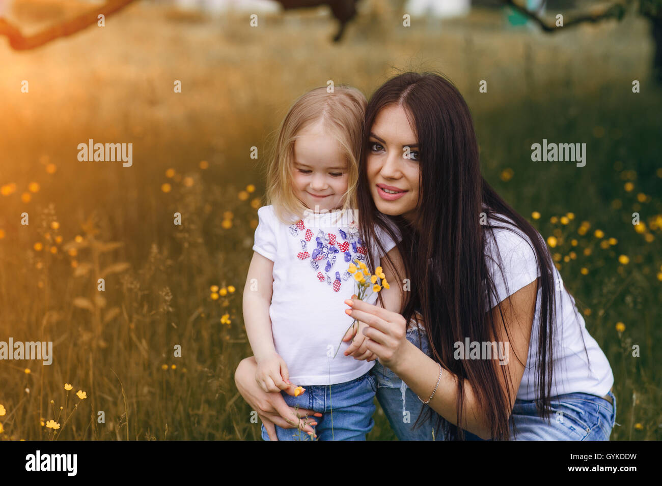child near tree with mom Stock Photo - Alamy