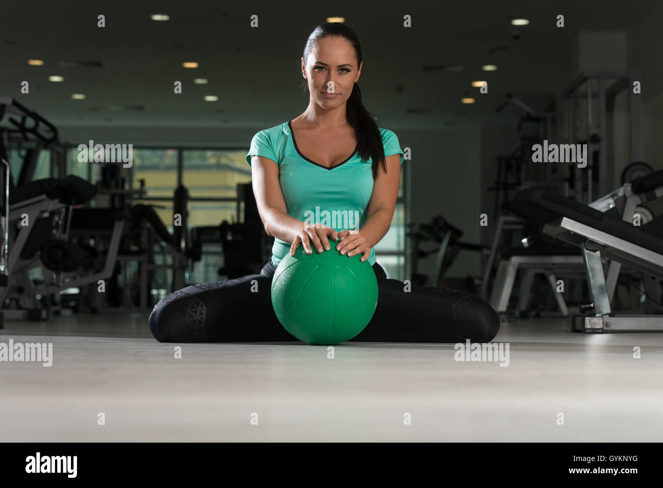 Attractive Woman Doing Stretching With Medicine Ball As Part Of ...