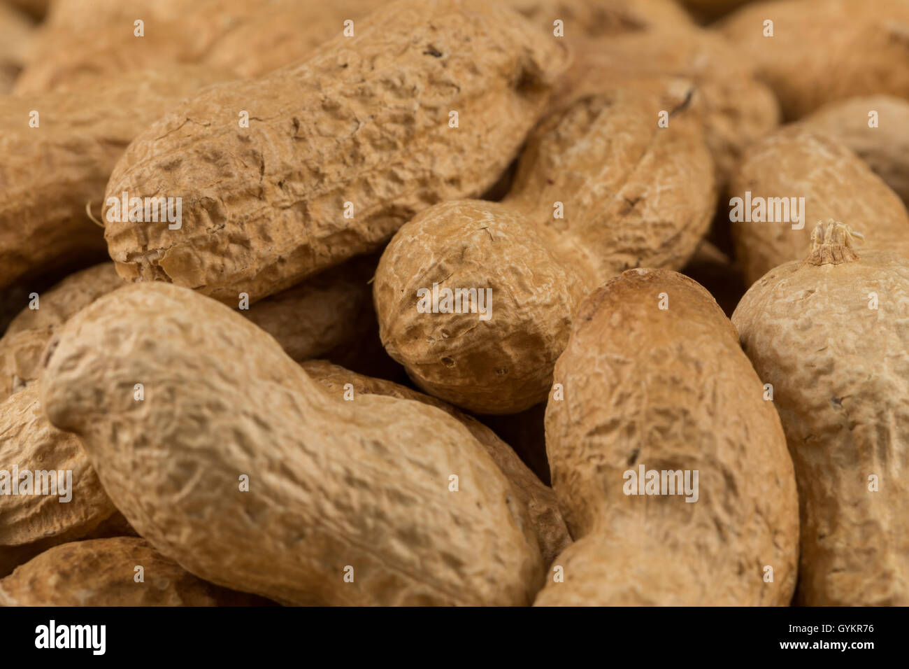 Pile of peanuts shells close up for background Stock Photo - Alamy