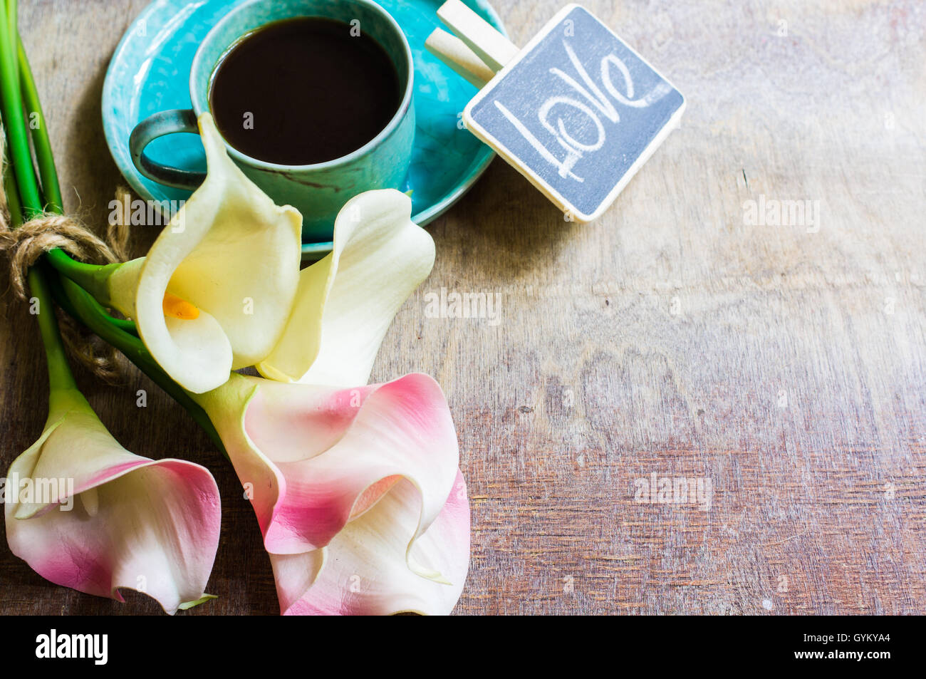Cup of coffee and calla lily flowers on rusty background Stock Photo ...