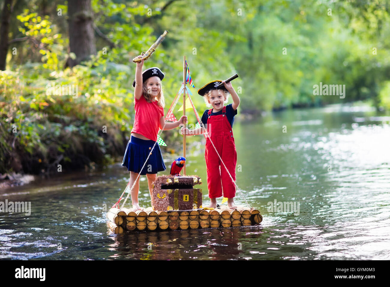 Kids dressed in pirate costumes and hats with treasure chest ...