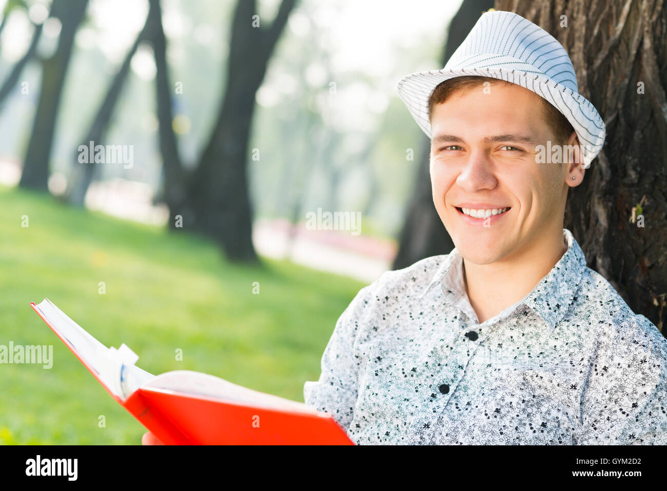 young man reading a book Stock Photo - Alamy