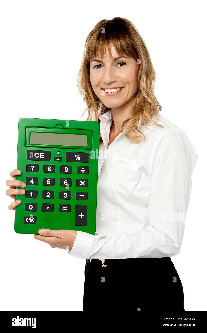 Smiling lady showing big green calculator Stock Photo - Alamy