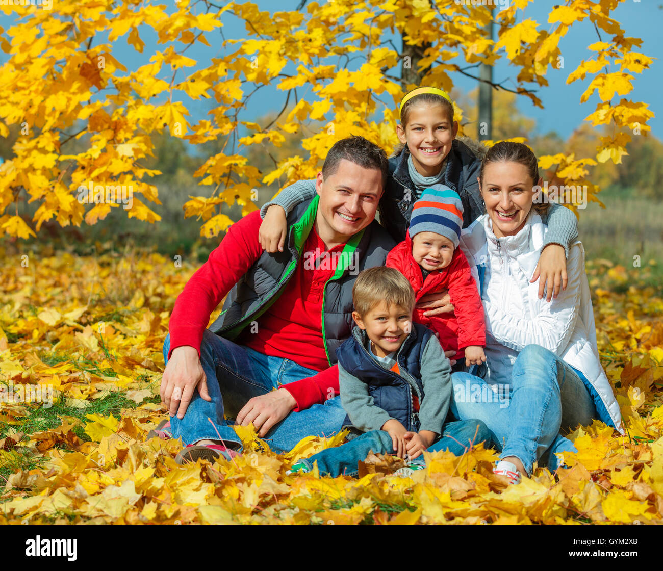Family at autumn park Stock Photo - Alamy