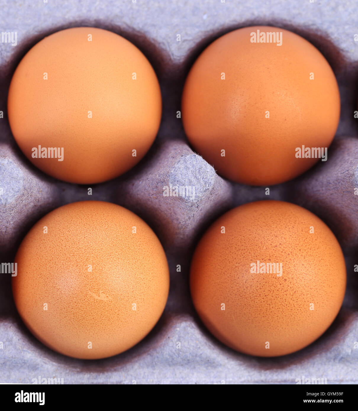 Four brown eggs in egg box Stock Photo - Alamy