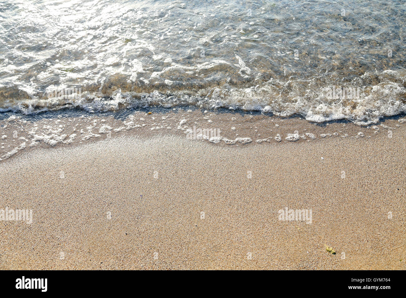 Sand and wave on the sea Stock Photo - Alamy