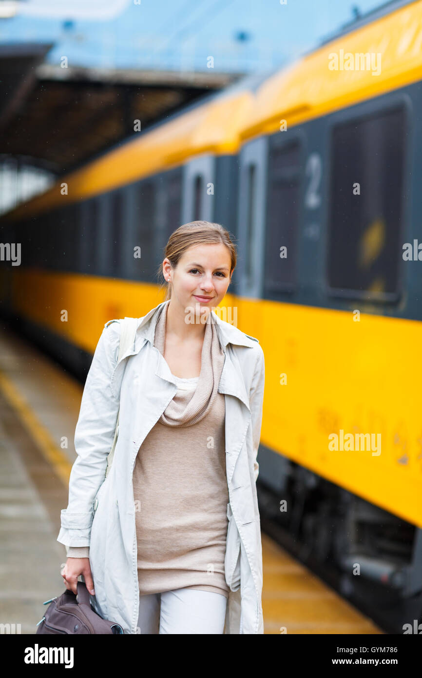 Pretty young woman at a train station (color toned image Stock Photo ...