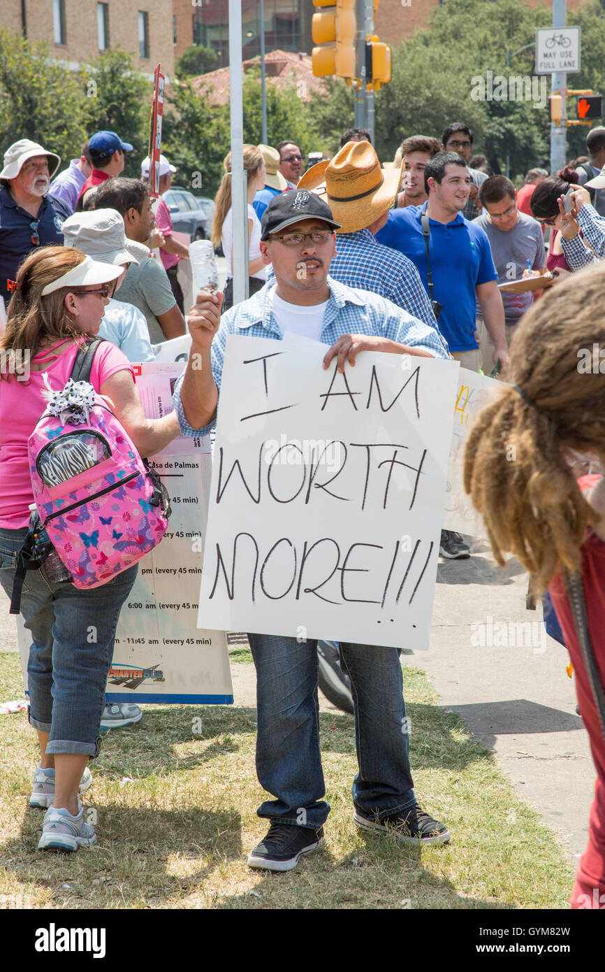A protester holds a sign at a minimum wage protest Stock Photo - Alamy