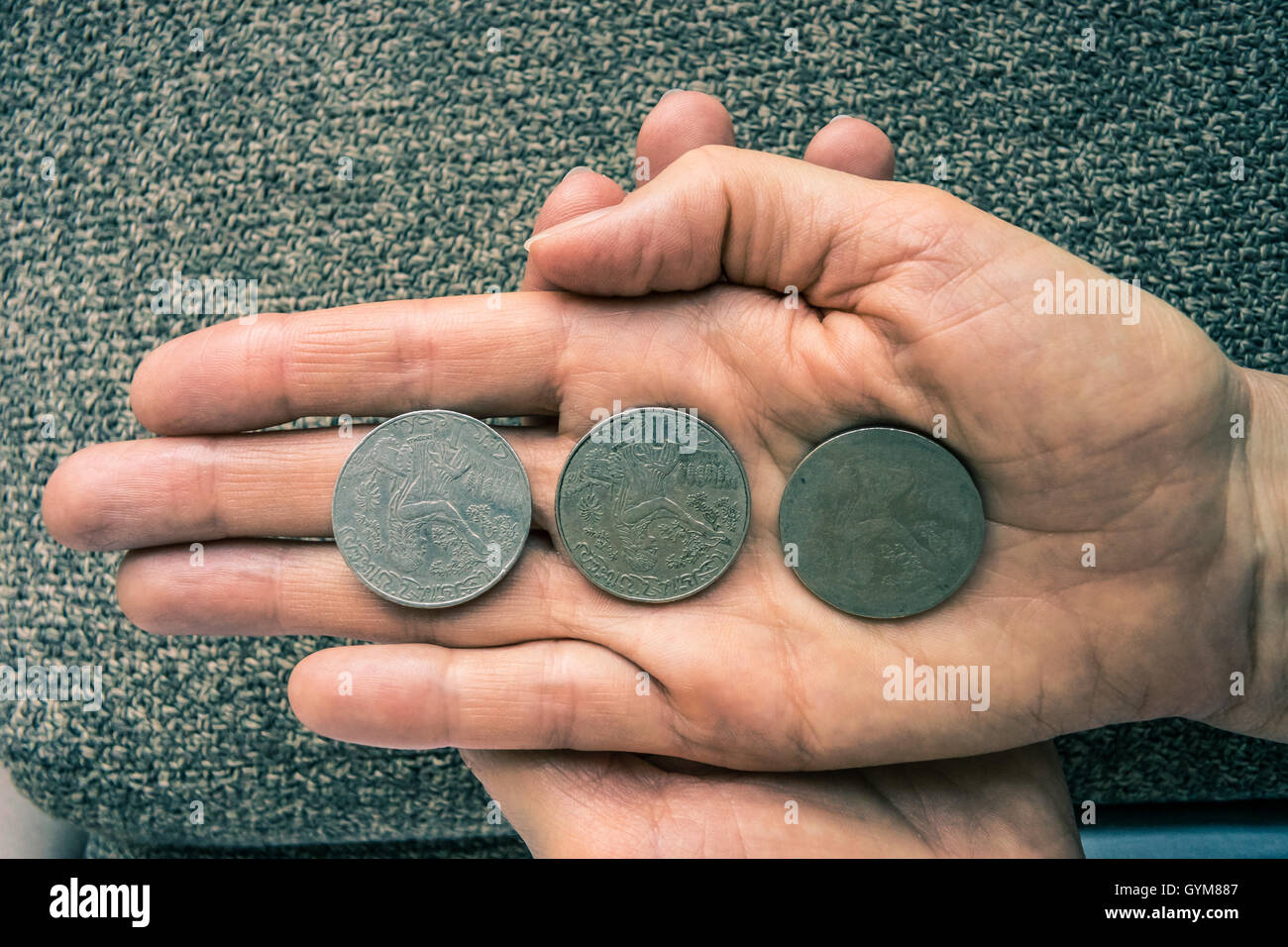 Three Tunisian coins on the woman's palm Stock Photo - Alamy