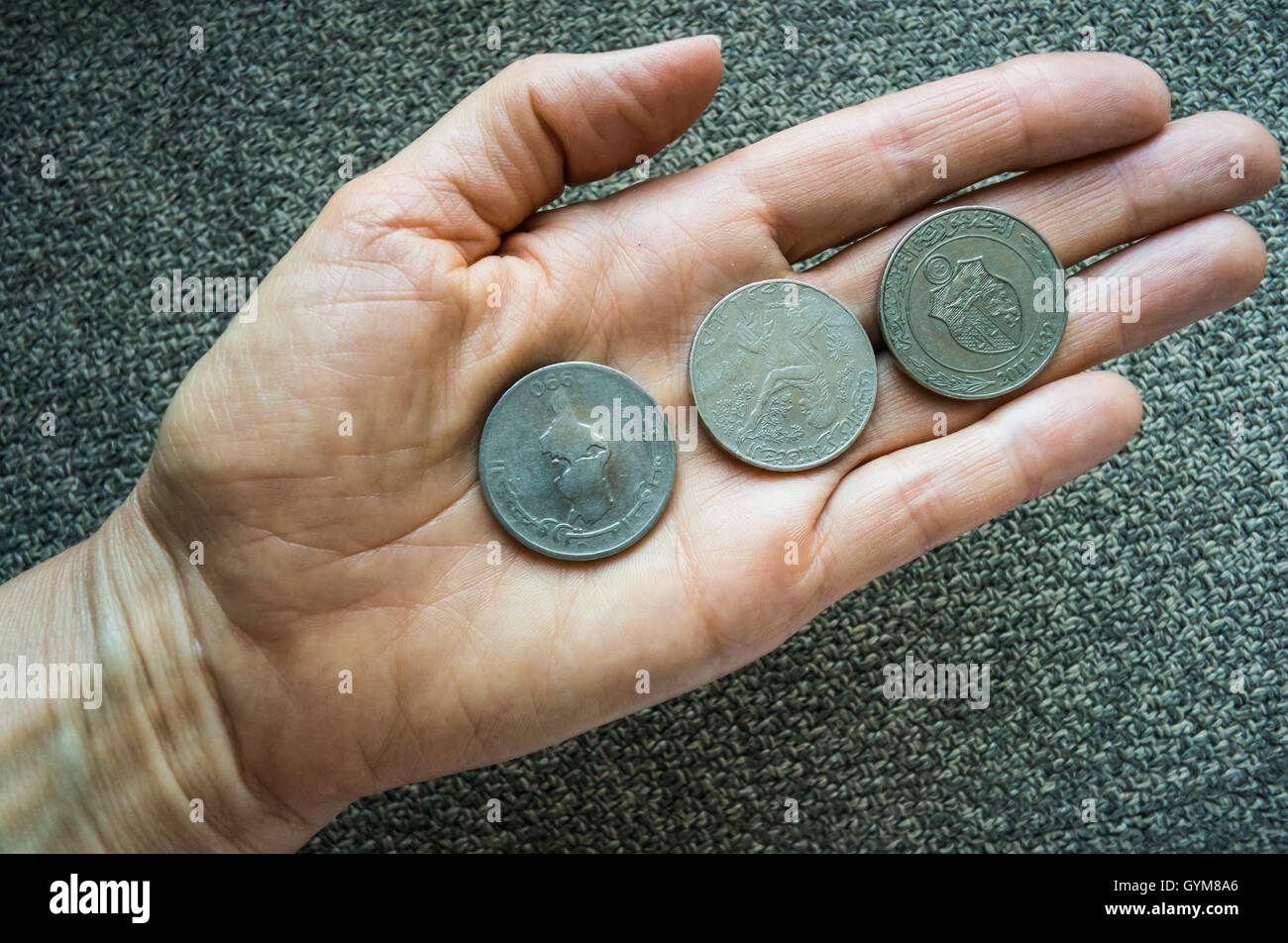 Holding three coins hi-res stock photography and images - Alamy