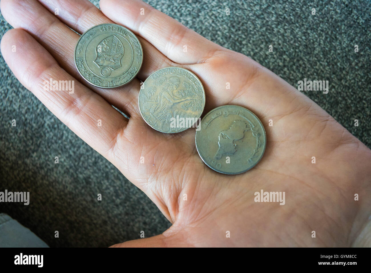 Holding three coins hi-res stock photography and images - Alamy