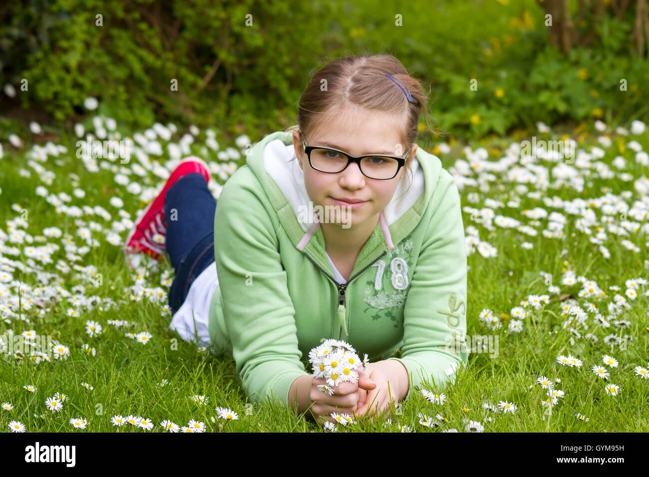 young girl picking daisies Stock Photo - Alamy
