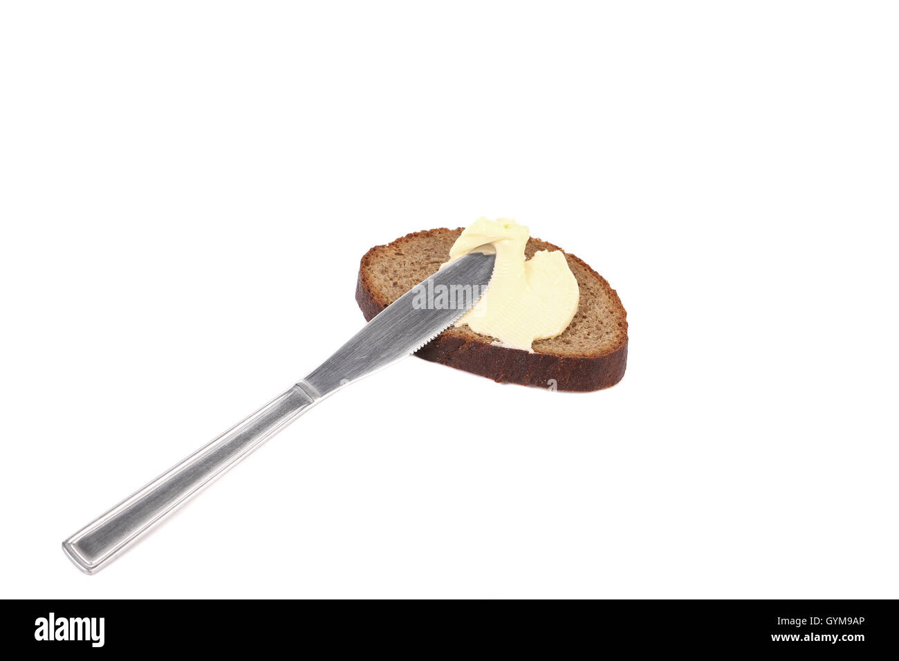 Buttering knife on brown bread Stock Photo - Alamy