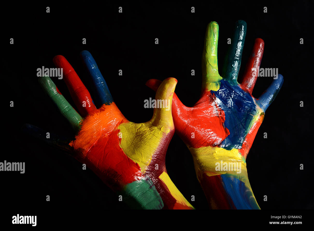 Colorful hands painted with oil paint on black background Stock Photo ...