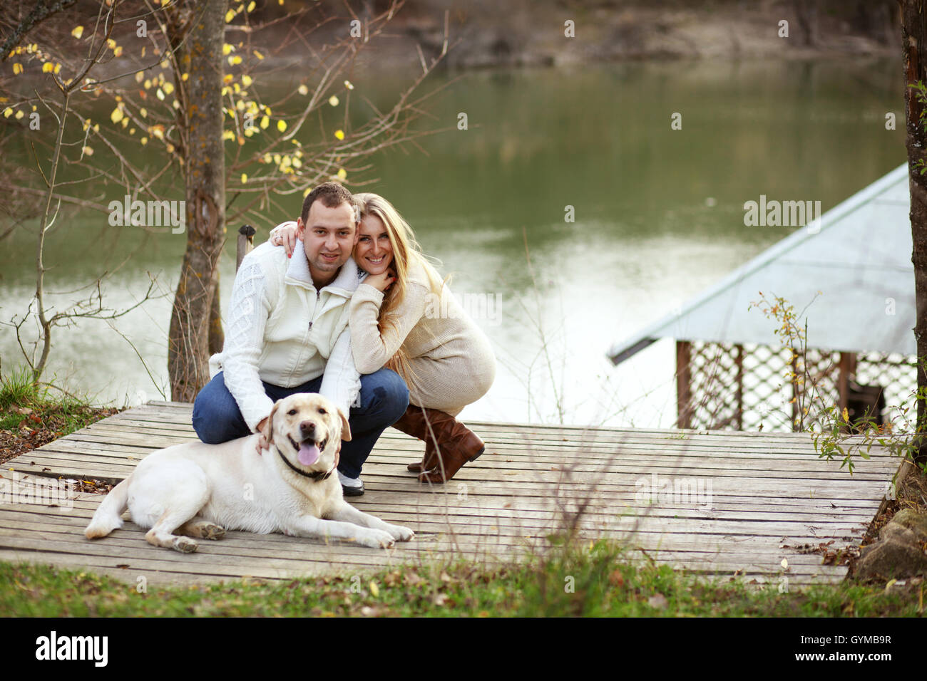 Couple with dog Stock Photo - Alamy