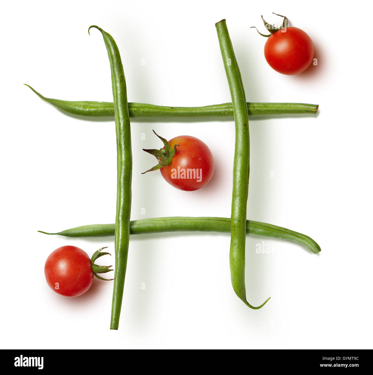 Food game Tic-tac-toe. diet beans and cherry tomatoes on a white ...
