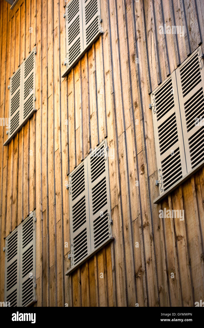 Closed shutters on the facade of a wooden house in a French village ...