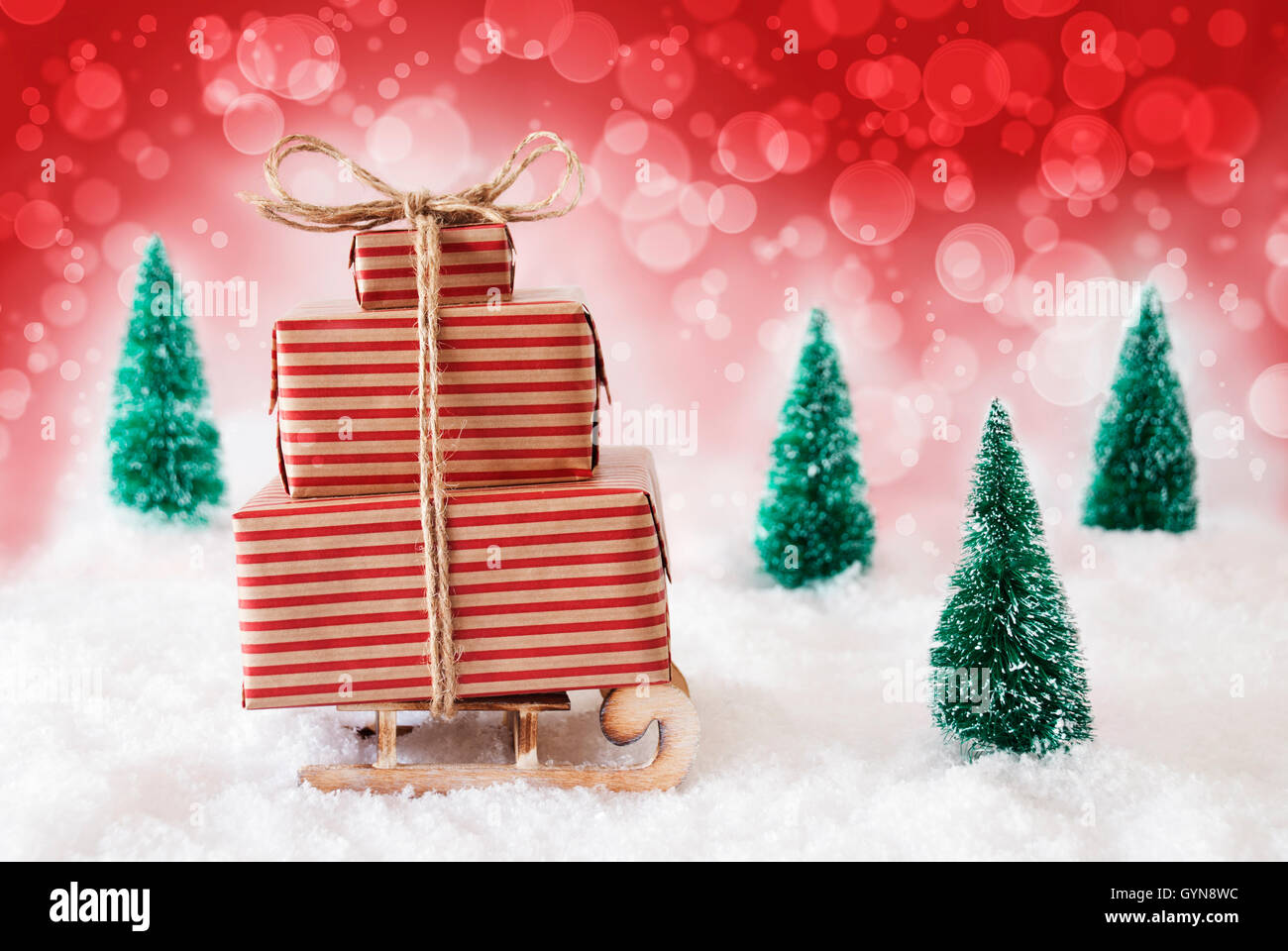 Christmas Sled On Snow With Red Background Stock Photo - Alamy