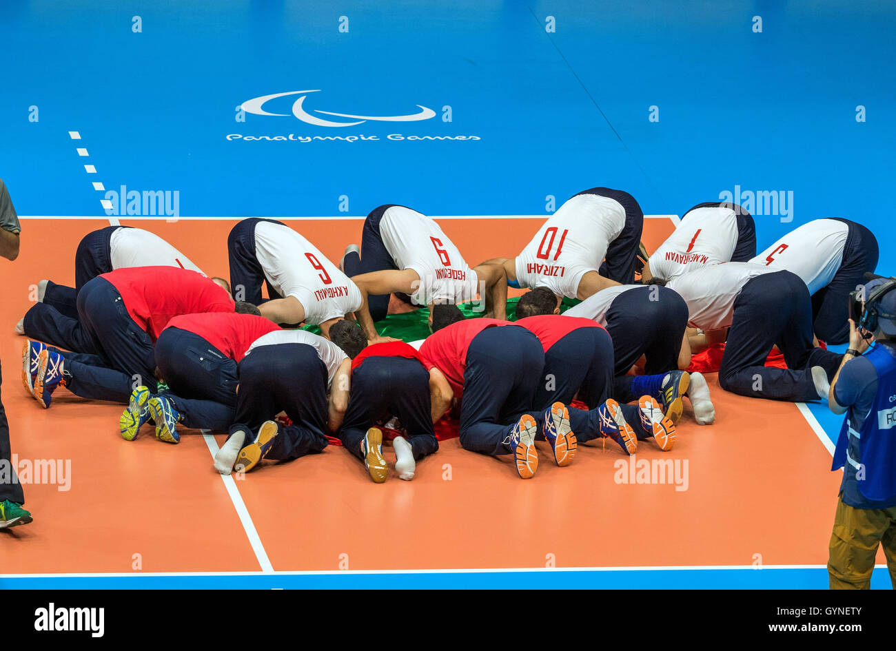 The Iranian sitting volleyball team pray after winning the gold medal ...