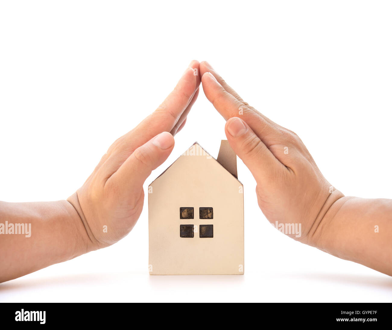 hands covering a small family house, home insurance concept or ...