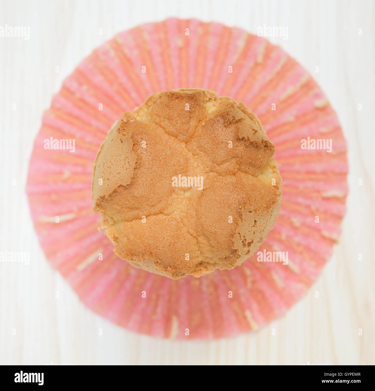top view homemade cup cake with the outer opened on a wood background ...