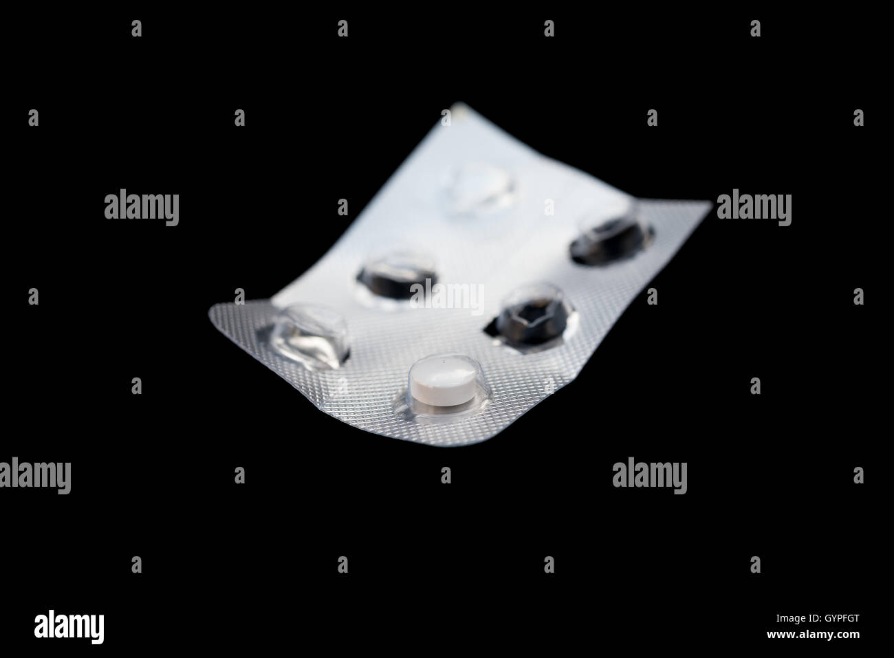 last piece of pill on black background Stock Photo - Alamy