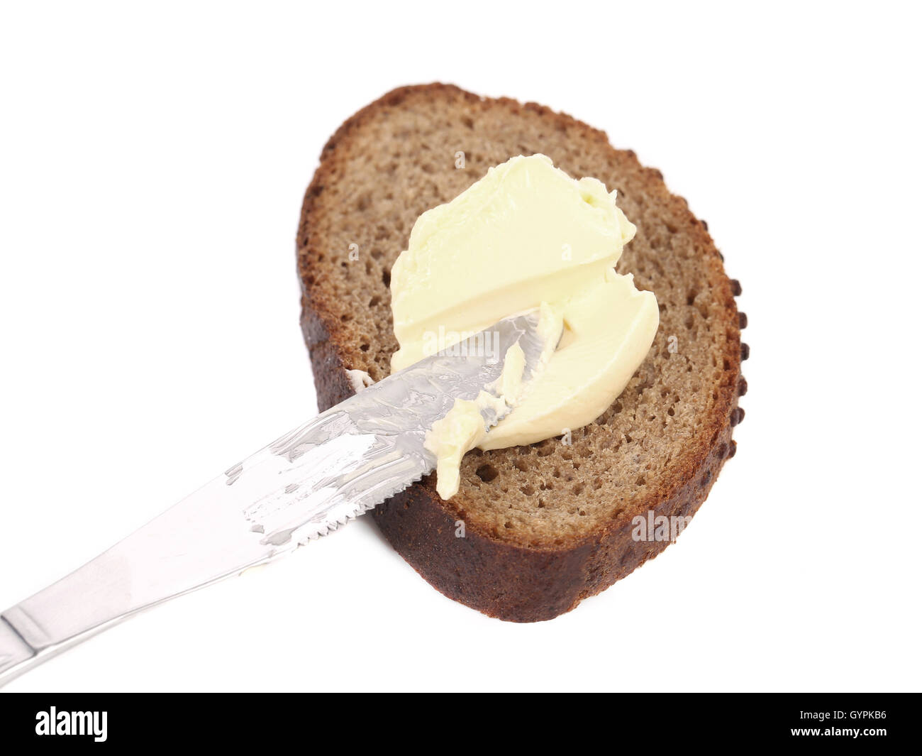 Buttering knife on brown bread Stock Photo - Alamy