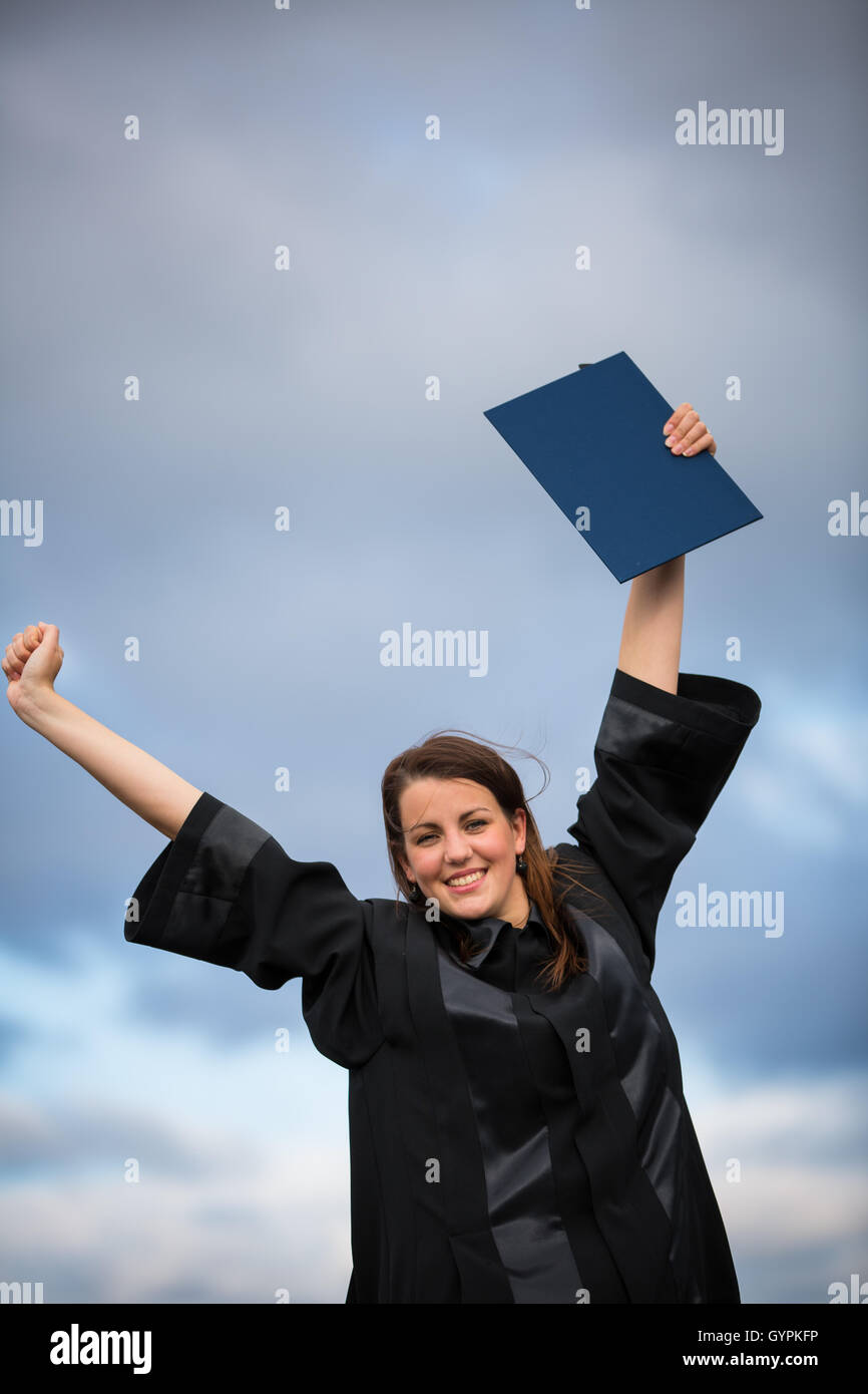 Pretty, young woman celebrating joyfully her graduation Stock Photo - Alamy