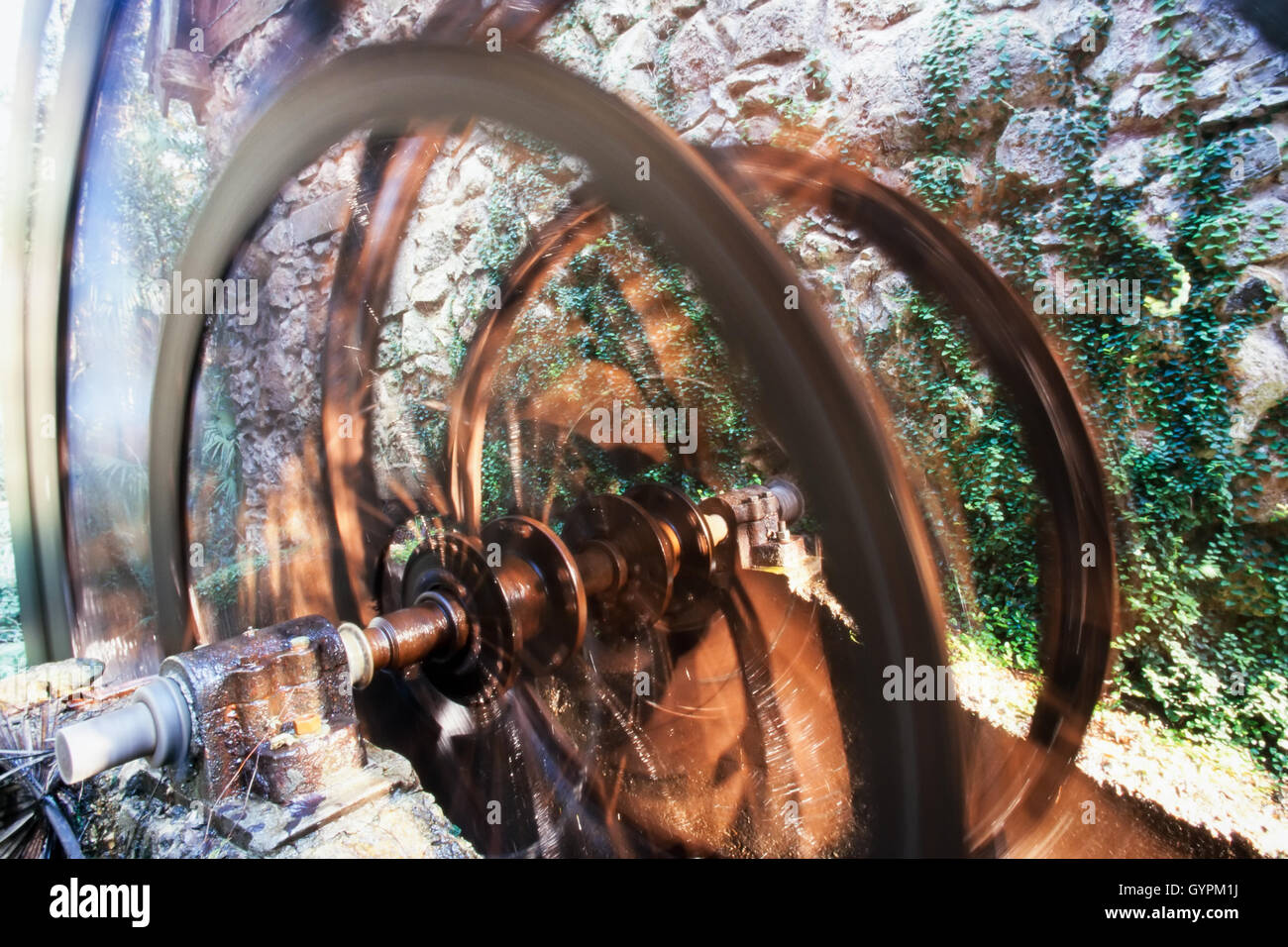 Working ancient millwheel blurred by rotation Stock Photo - Alamy