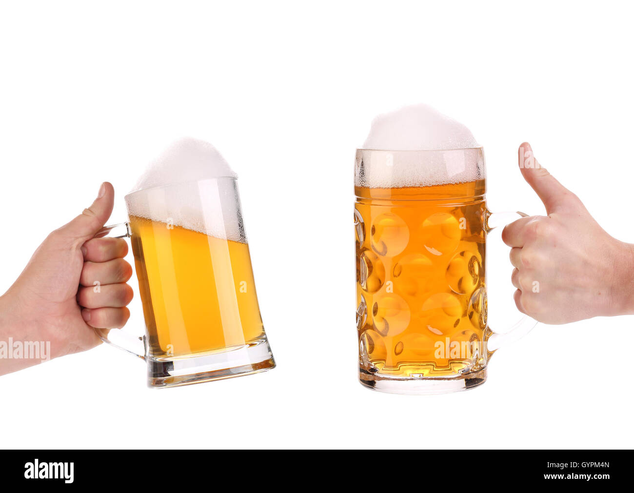 Two full beer mugs in hand Stock Photo - Alamy
