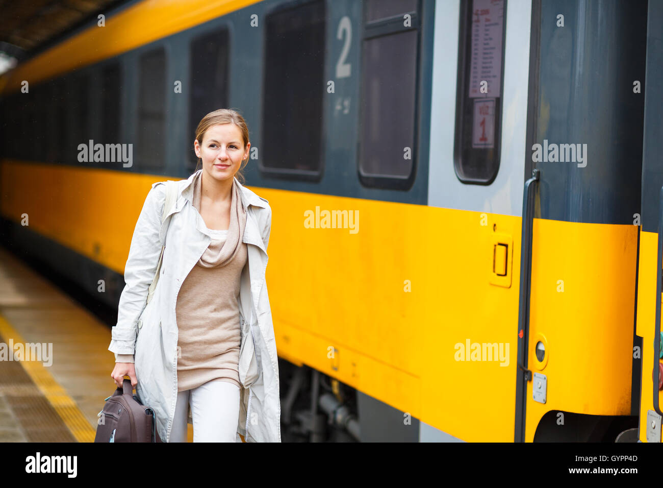 Pretty young woman at a train station (color toned image Stock Photo ...