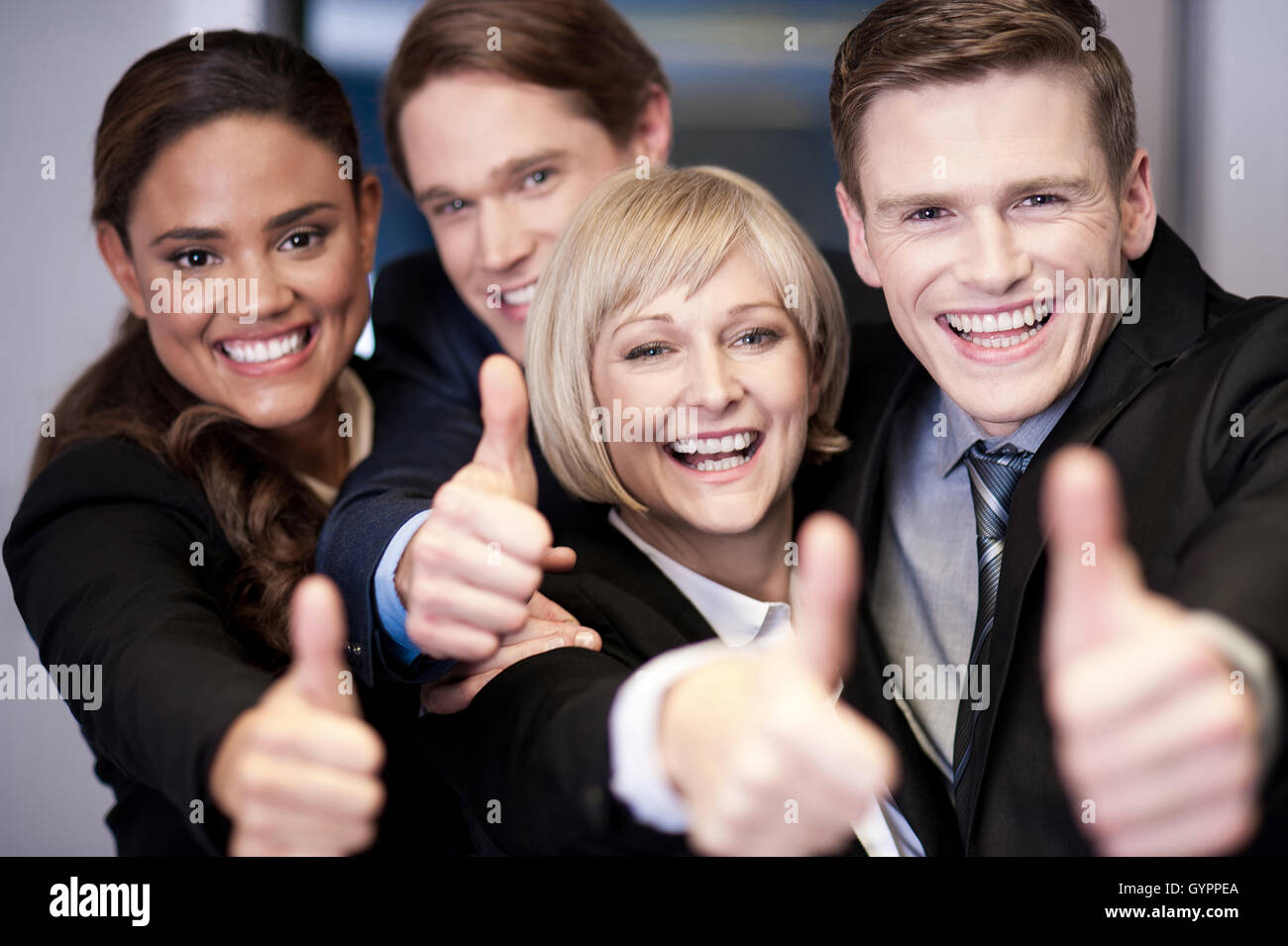 Corporate team gesturing thumbs up Stock Photo - Alamy