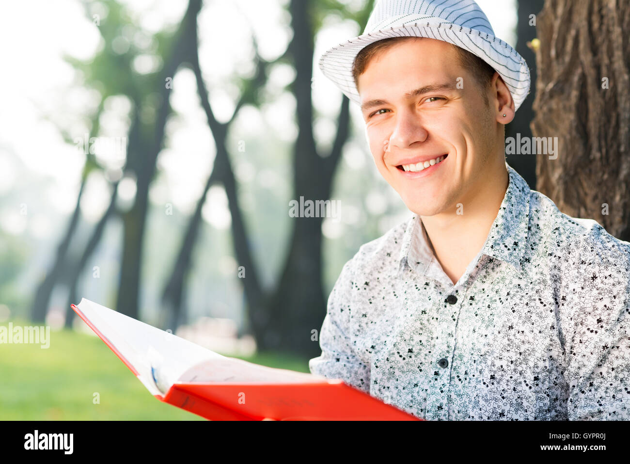 young man reading a book Stock Photo - Alamy