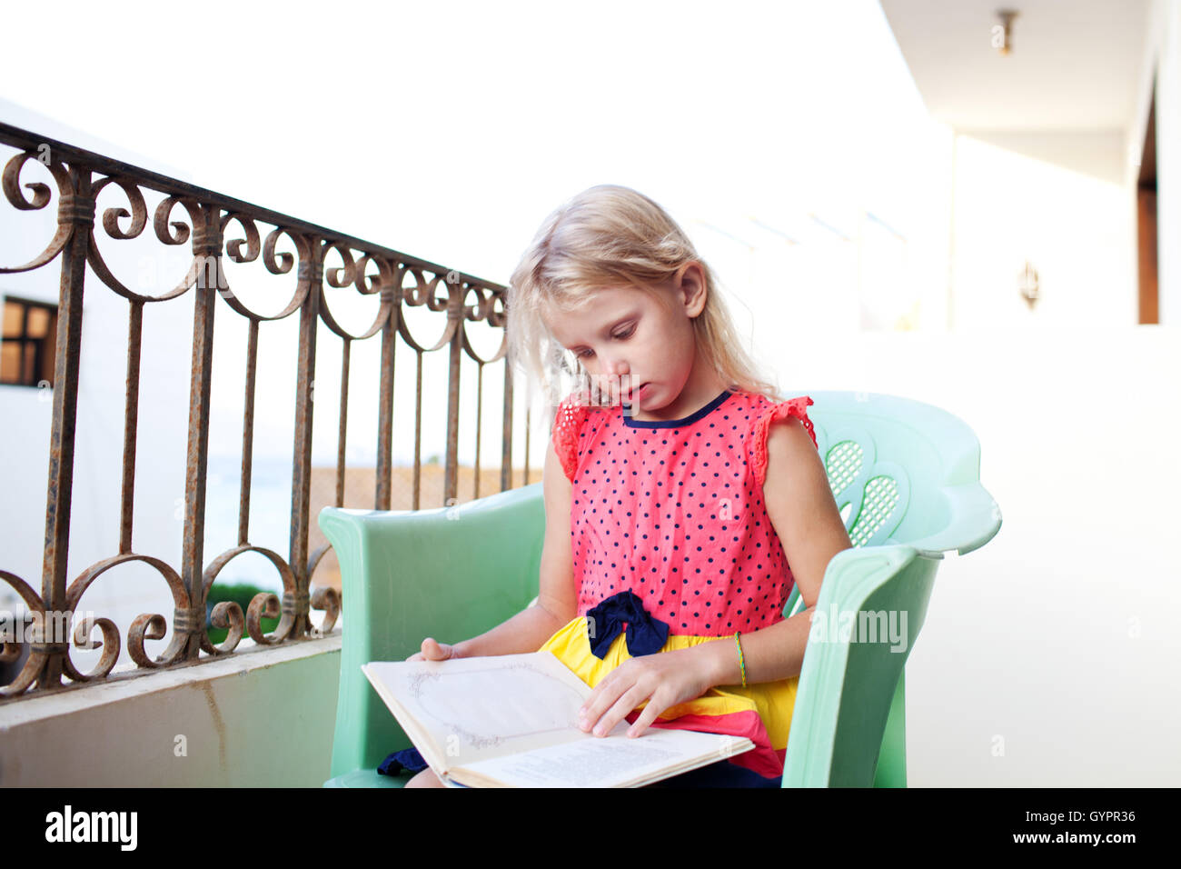 small girl reading on the balcony Stock Photo - Alamy