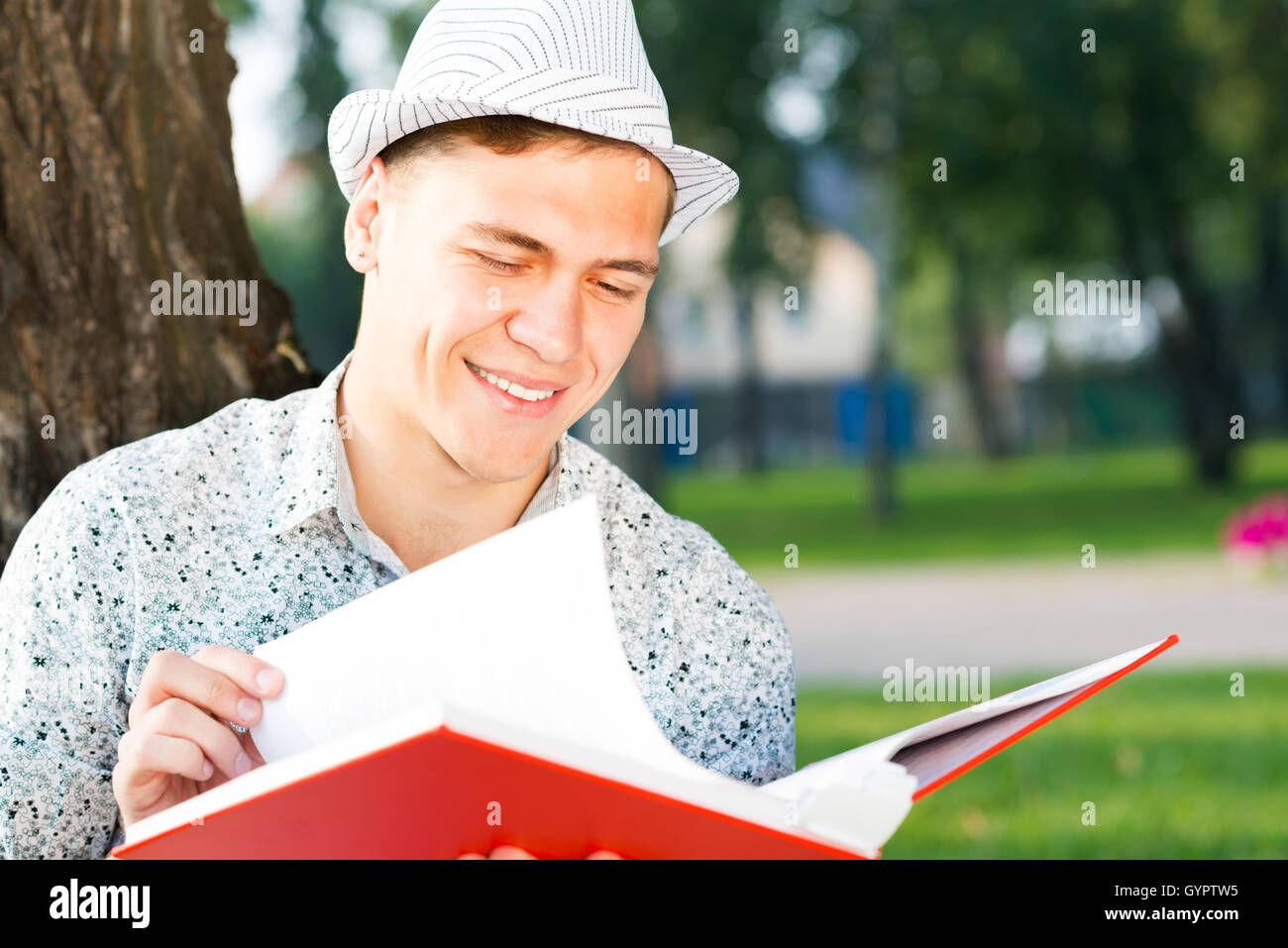 young man reading a book Stock Photo - Alamy