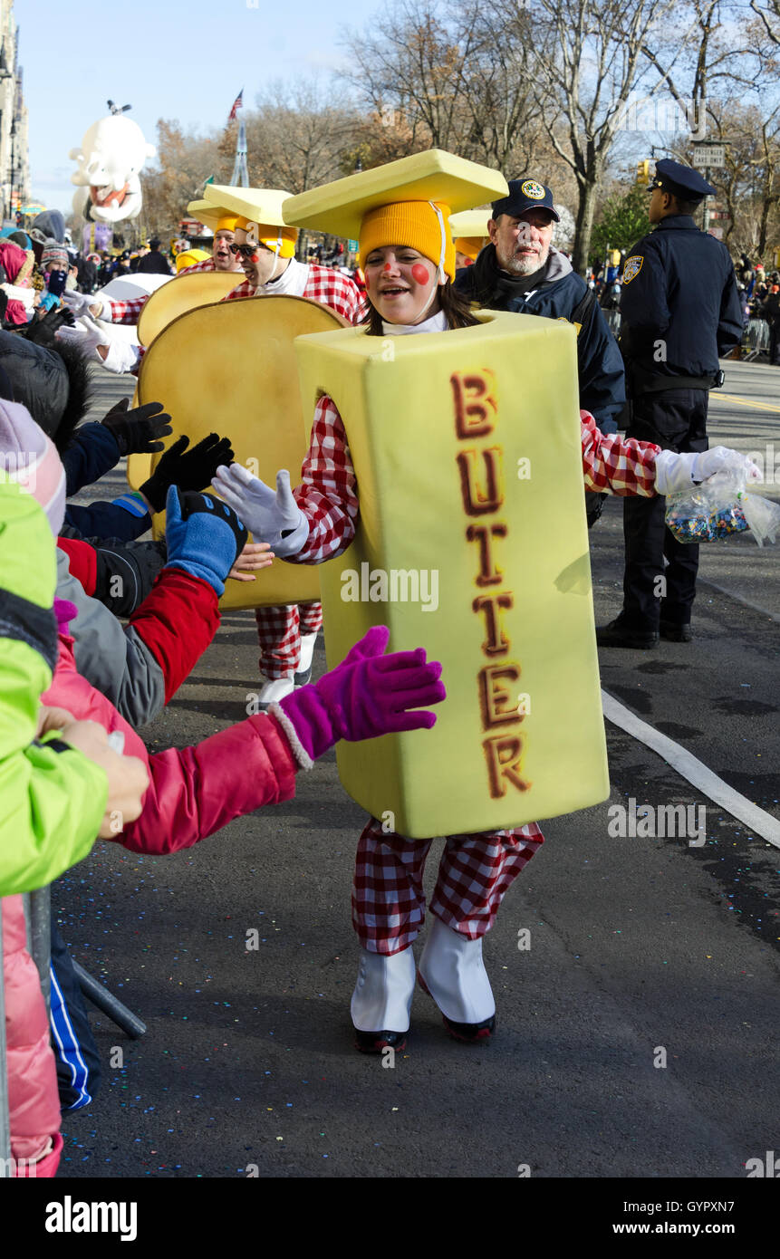 A clown dressed as a stick of butter high-fives the crowd at the Macy's ...
