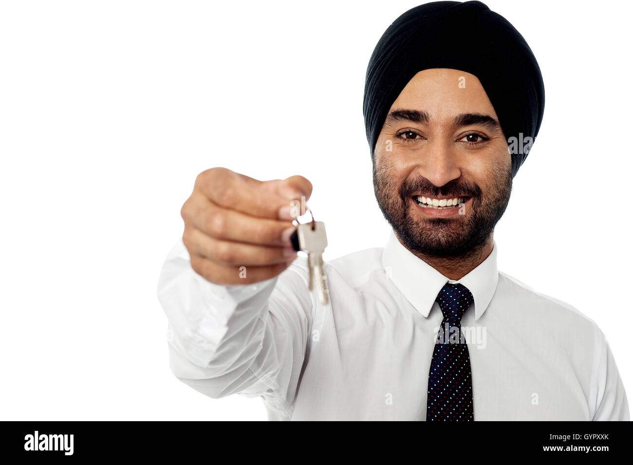 Smiling corporate guy holding a key Stock Photo - Alamy