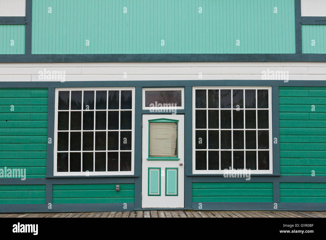 Small store front entrance to green wooden house Stock Photo - Alamy