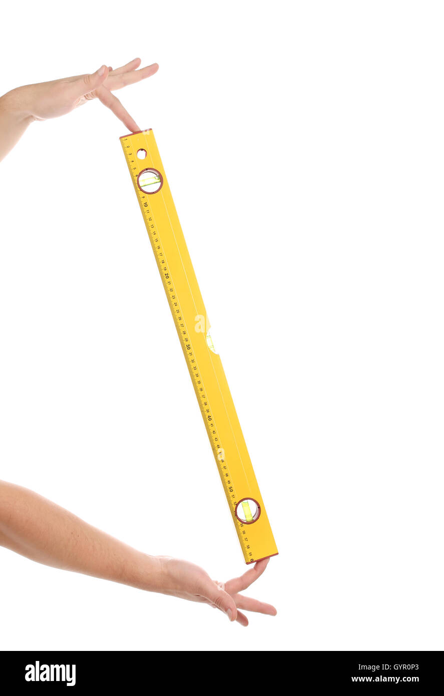 Yellow building level in hands Stock Photo - Alamy
