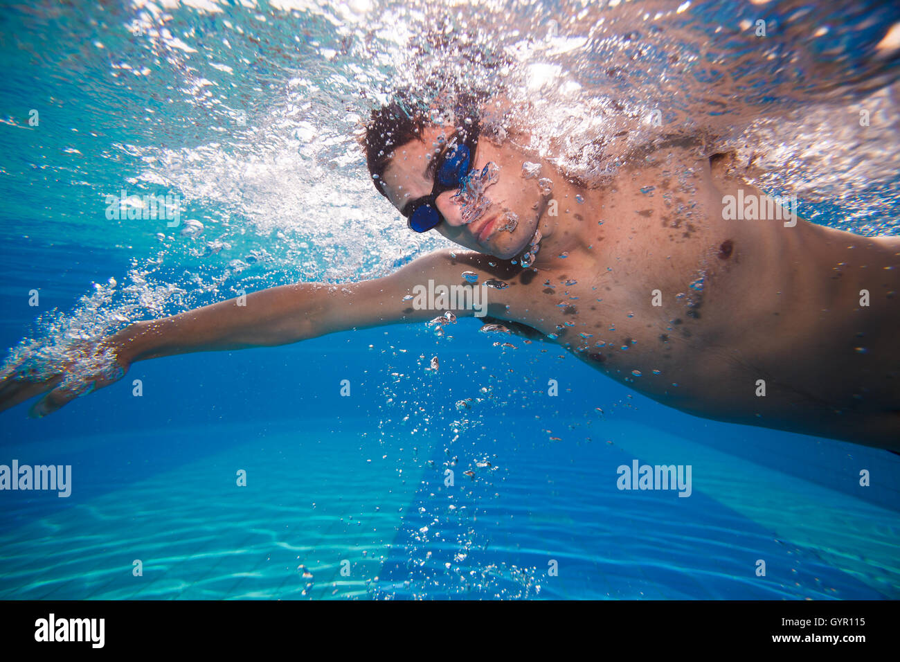 Young man swimming the front crawl in a pool - underwater shot Stock ...