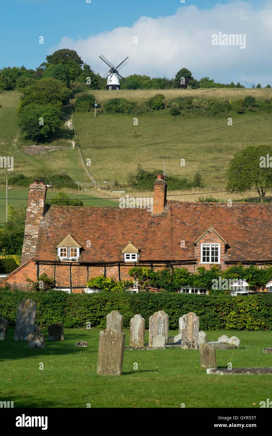 Turville Village showing the gravestones and Cobstone windmill in th ...