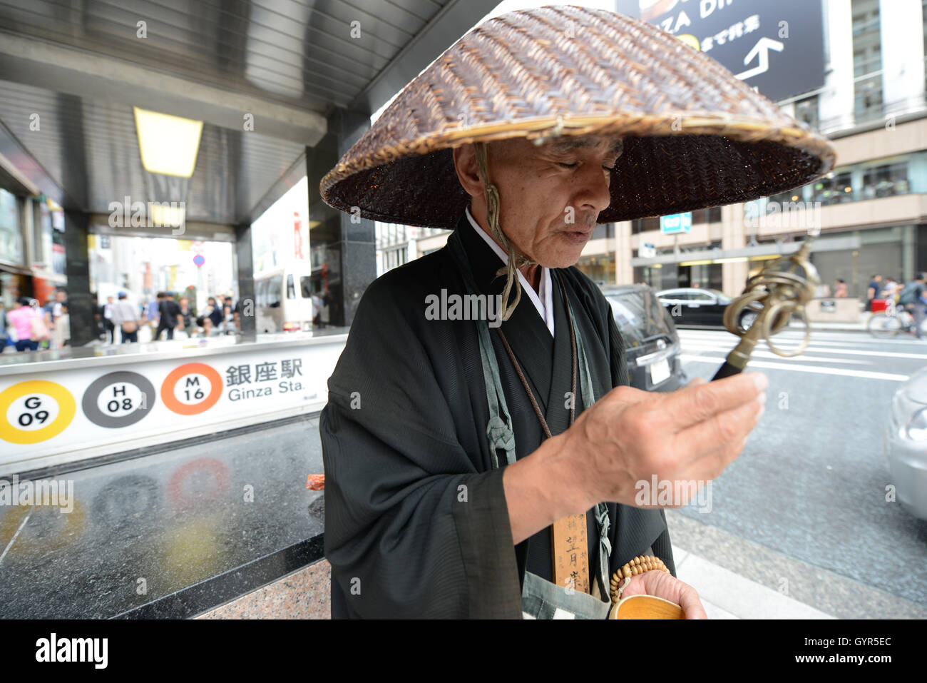 A Japanese Zen monk collecting alms outside the Ginza subway station in ...